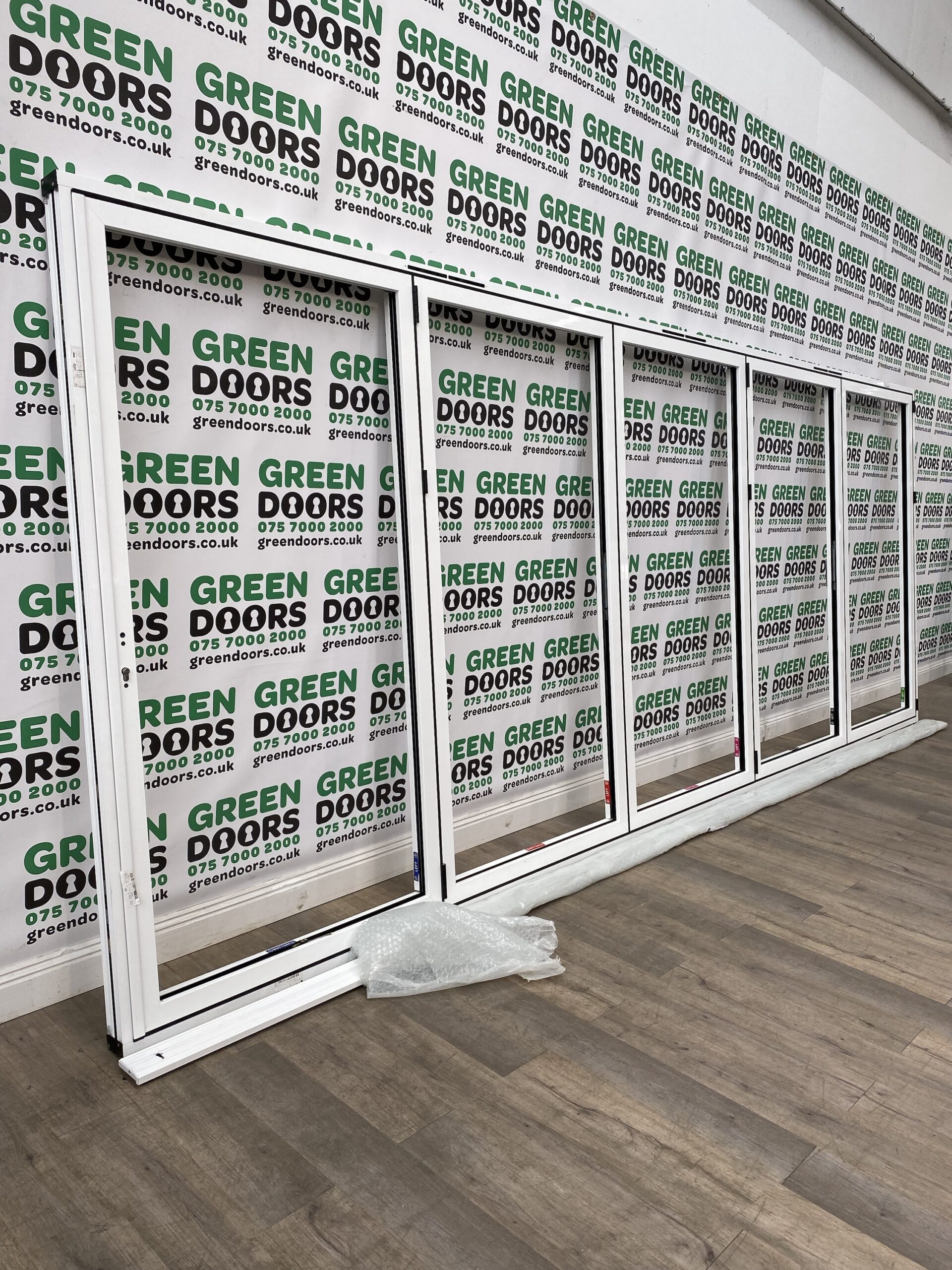 Korniche Aluminium White Bi-folding Doors | Green doors